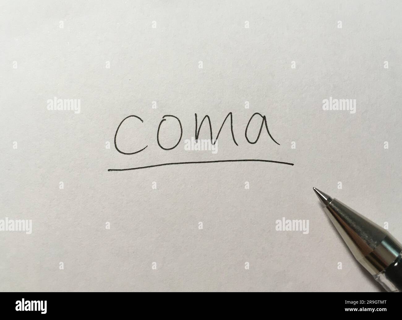 Coma concept word on paper background Stock Photo - Alamy