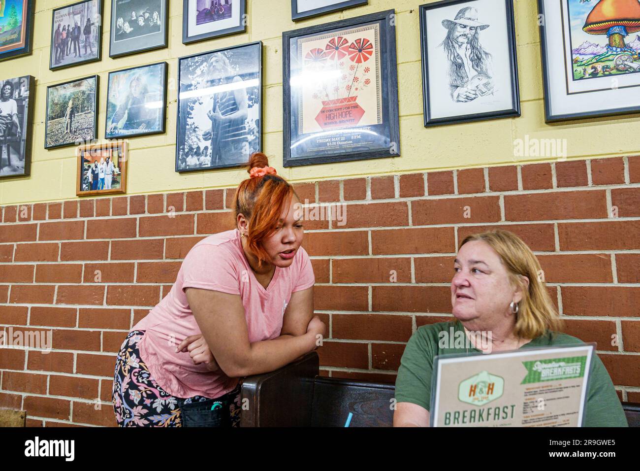 Black woman server helping diner customer hi-res stock photography and ...