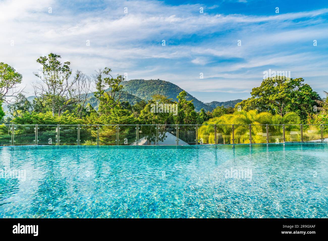 Beautiful rooftop swimming pool with the background of mountain scape ...