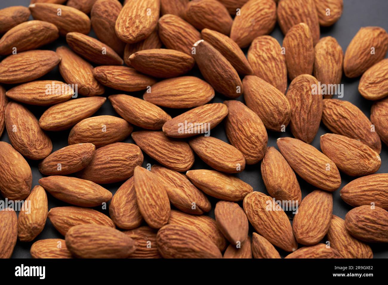 Whole shelled almond nuts kernels studio background Stock Photo - Alamy