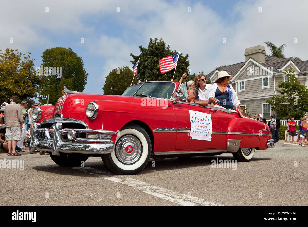 A gorgeous vintage car driving along in a 4th of July parade Stock ...