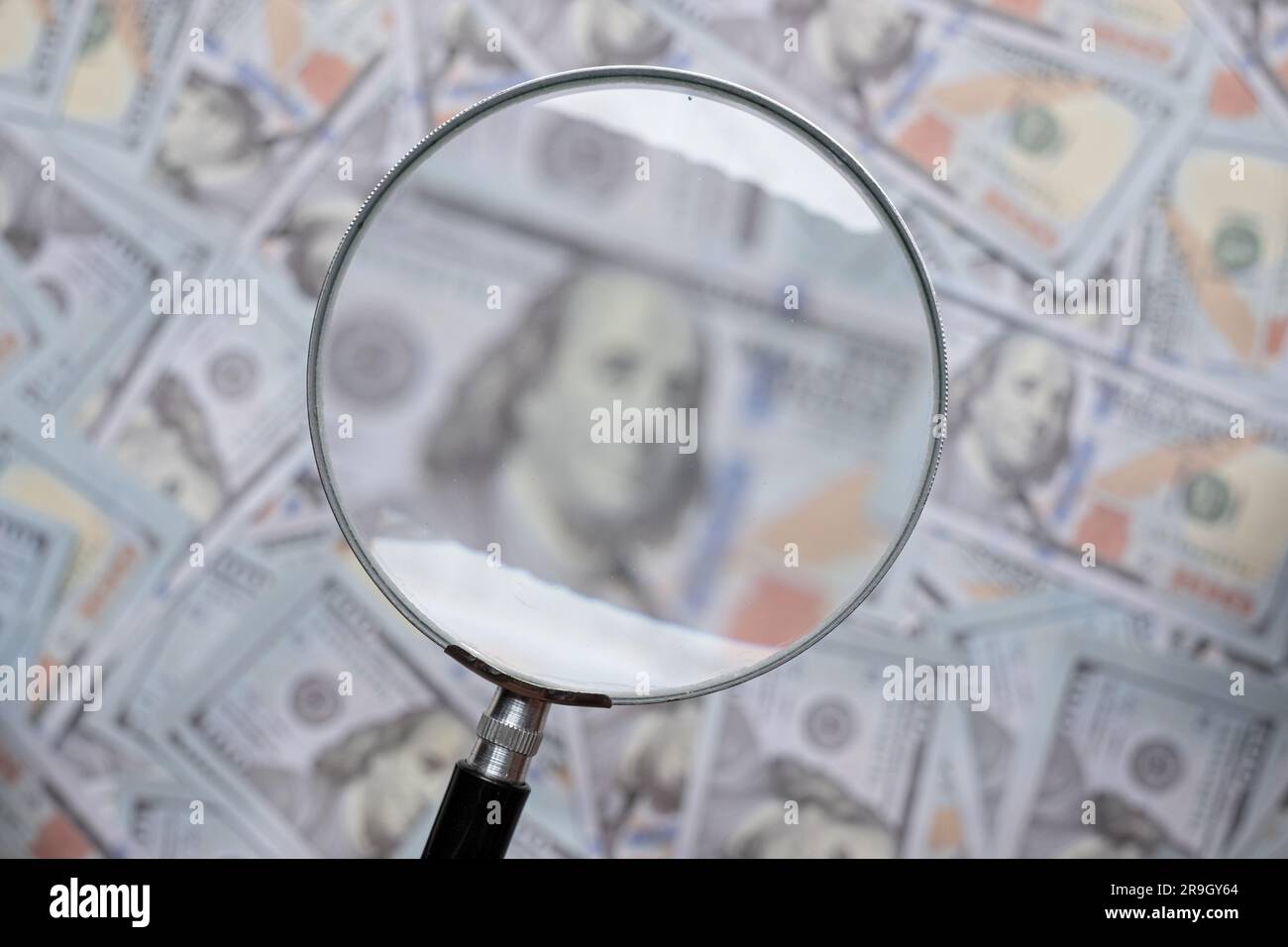 Blurred image of us dollar bill through magnifying lens checking ...