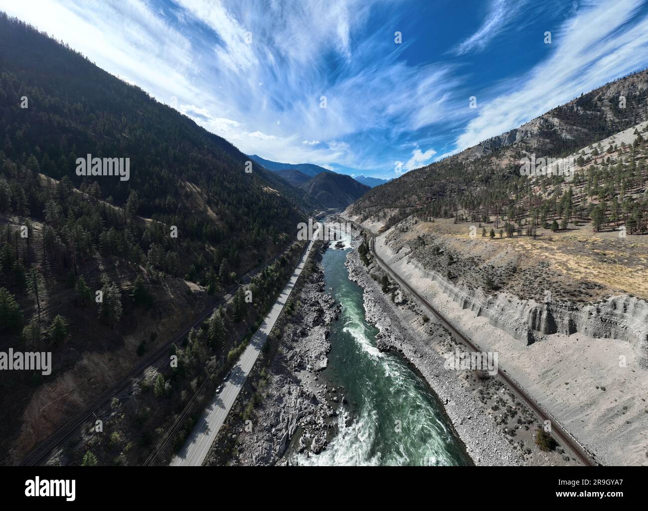 An aerial view of a river flowing through a winding valley and rolling ...