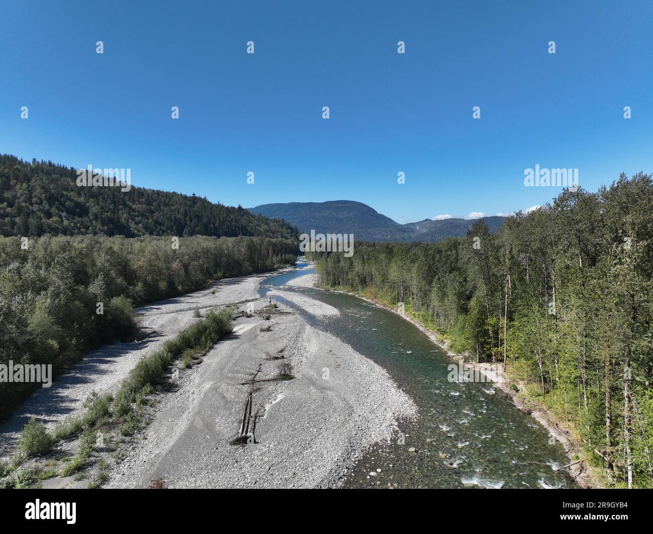 An aerial view of a river flowing through a winding valley and rolling ...