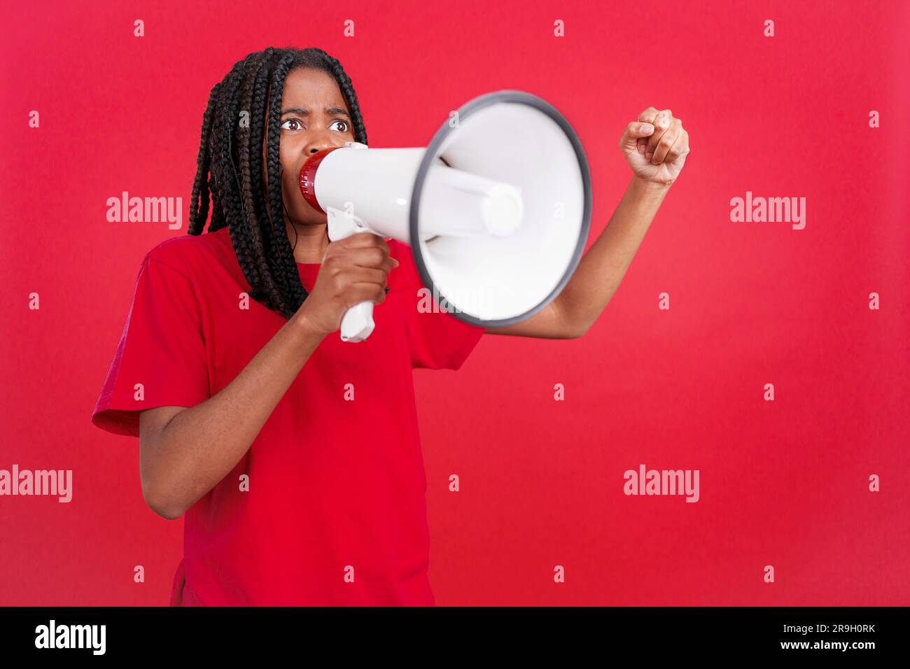Upset african woman yelling using a loudspeaker Stock Photo - Alamy