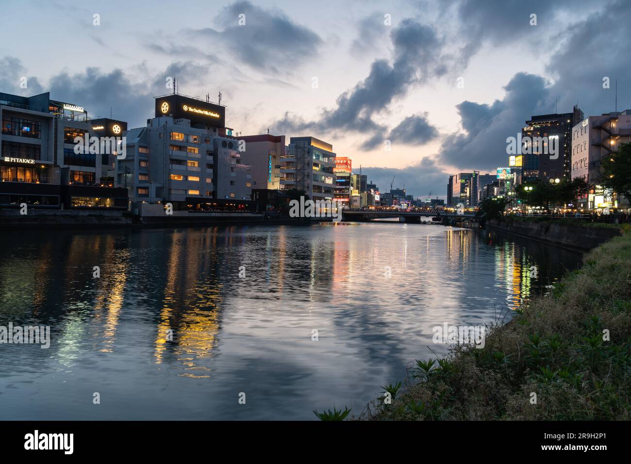 Fukuoka, Japan - May 20 2023: The sun sets over the Naka river that ...