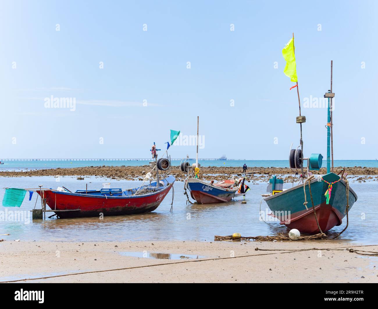 Traditional wooden fishing boats during low tide at Phala Beach in Ban ...