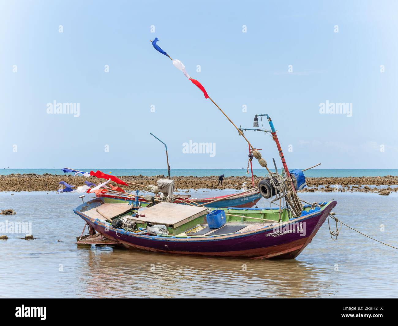 Traditional wooden fishing boats during low tide at Phala Beach in Ban ...
