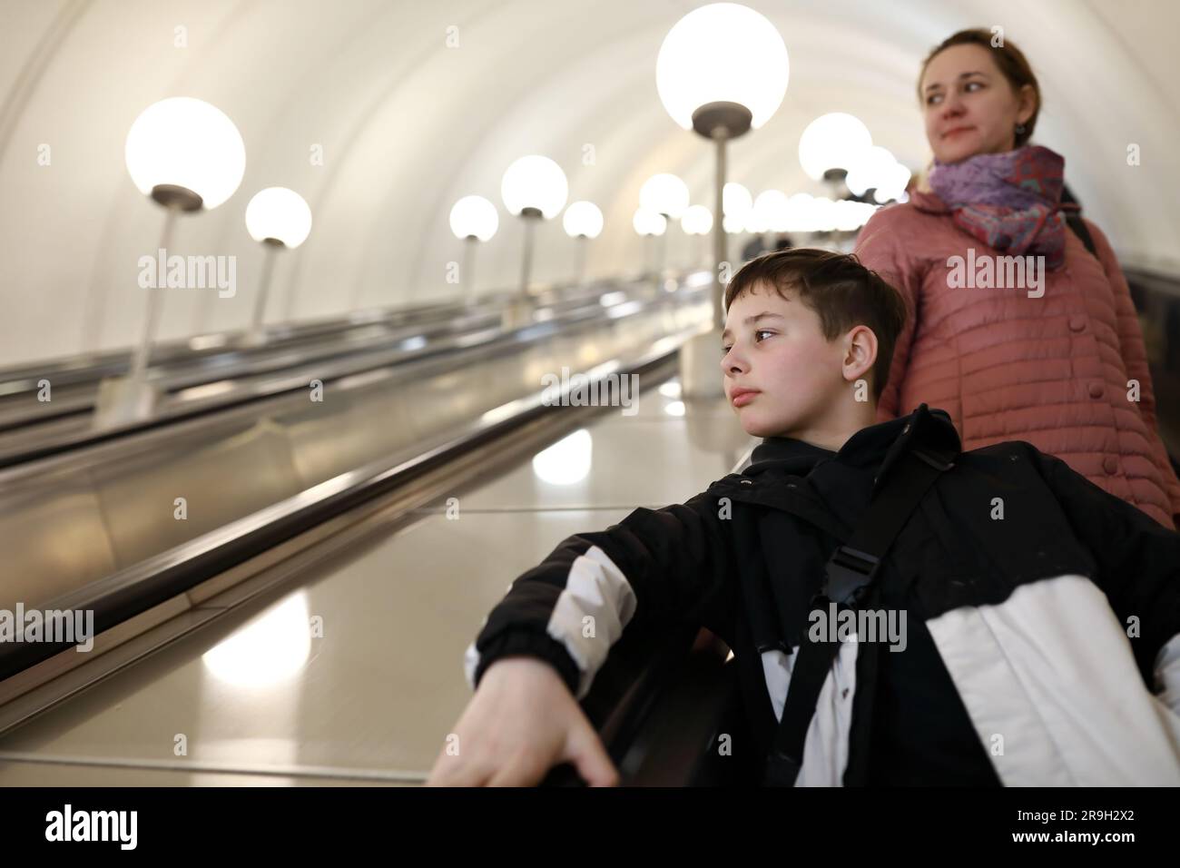 Two people going down escalator hi-res stock photography and images - Alamy