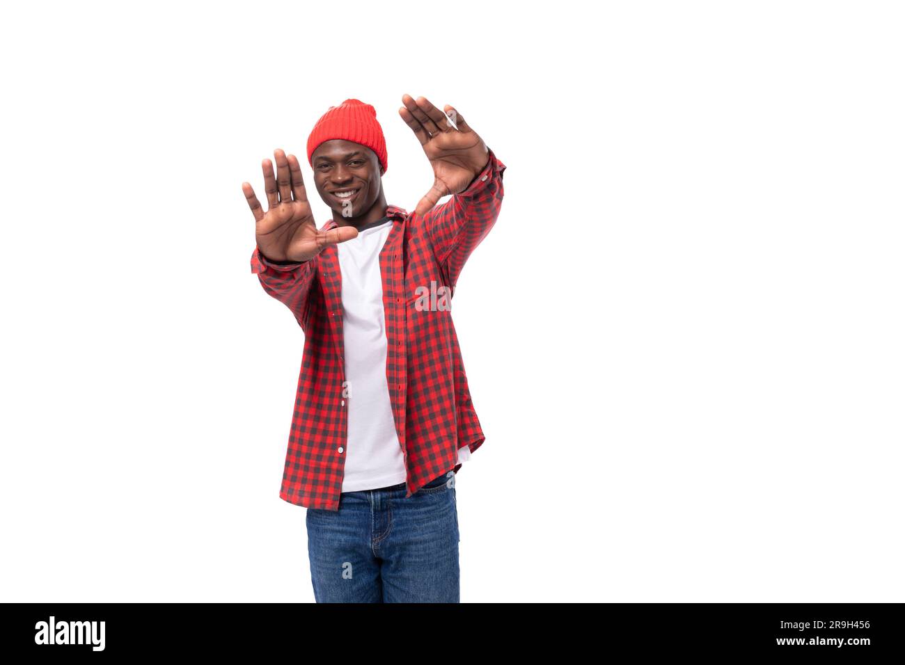 successful confident young american man in red cap and plaid shirt with ...
