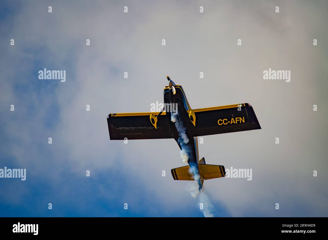 The yellow model CC-AFN aircraft flying against a bright blue sky Stock ...
