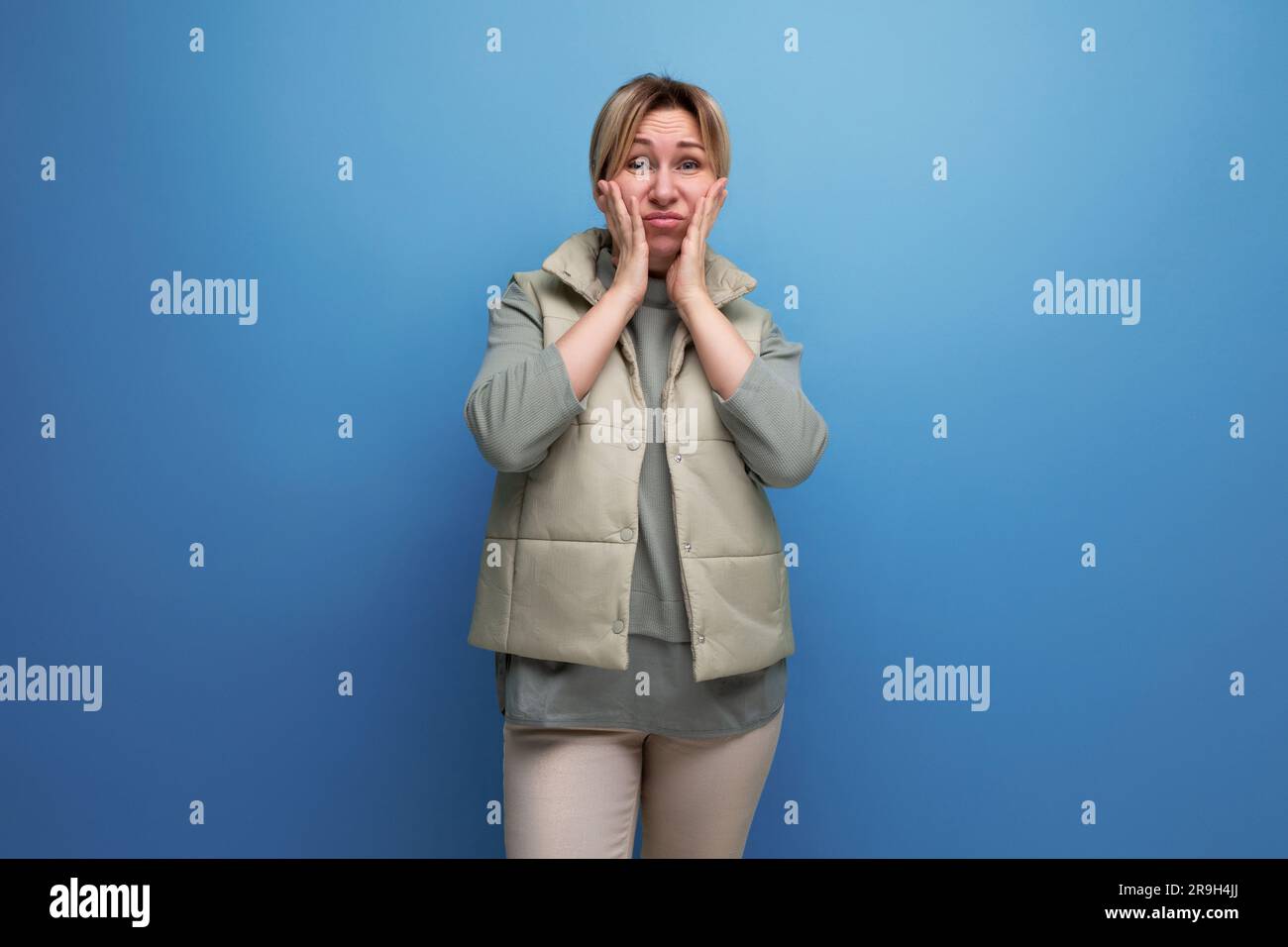 blond young woman in doubt feelings on studio background Stock Photo ...