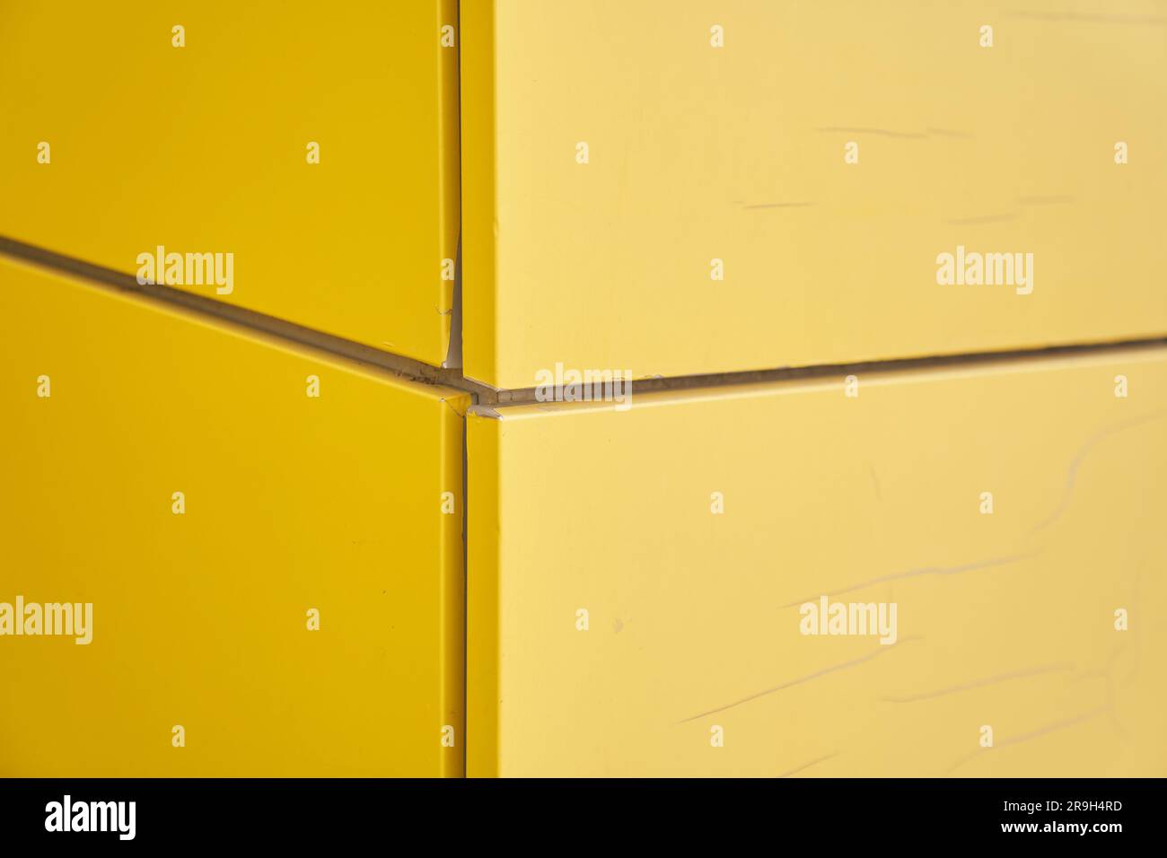 The exterior wall of the modern building is covered with yellow film ...