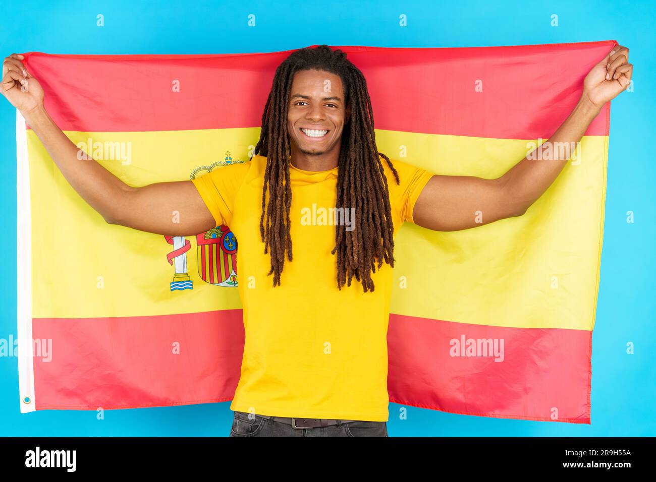 Happy latin man with dreadlocks raising a spanish national flag Stock ...