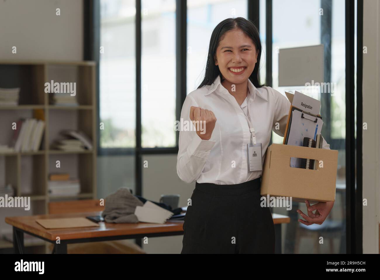 Resignation concept. Employee holding box of belongings in an office ...