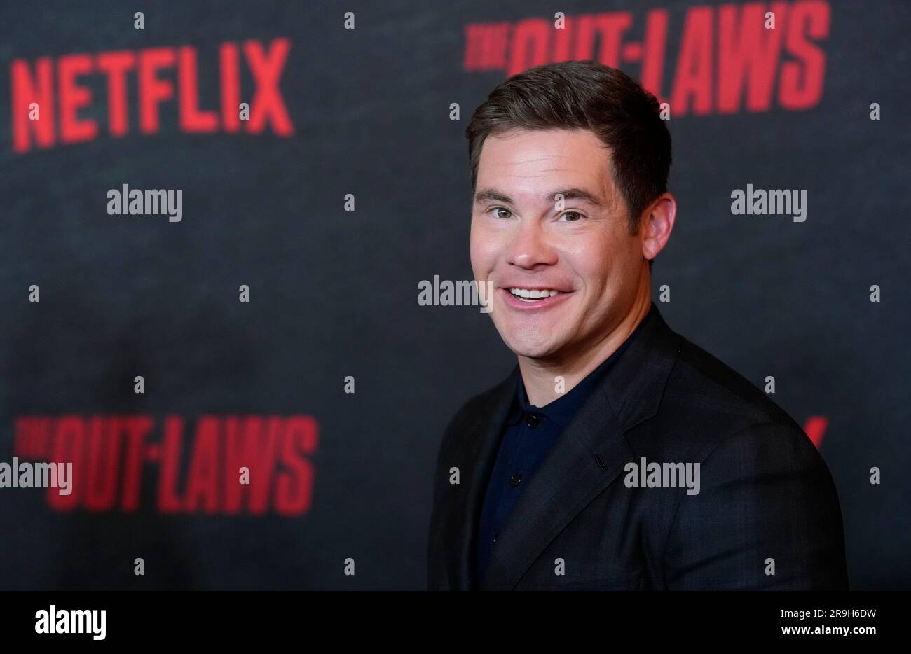 Adam Devine poses at a special screening of the film "The Out-Laws ...