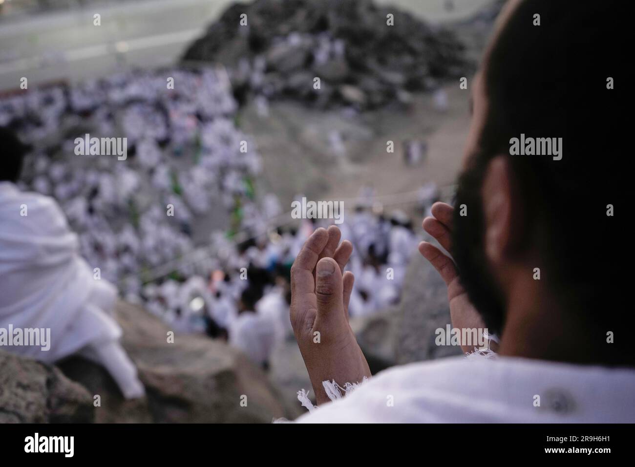 A Muslim pilgrim prays on the rocky hill known as the Mountain of Mercy ...