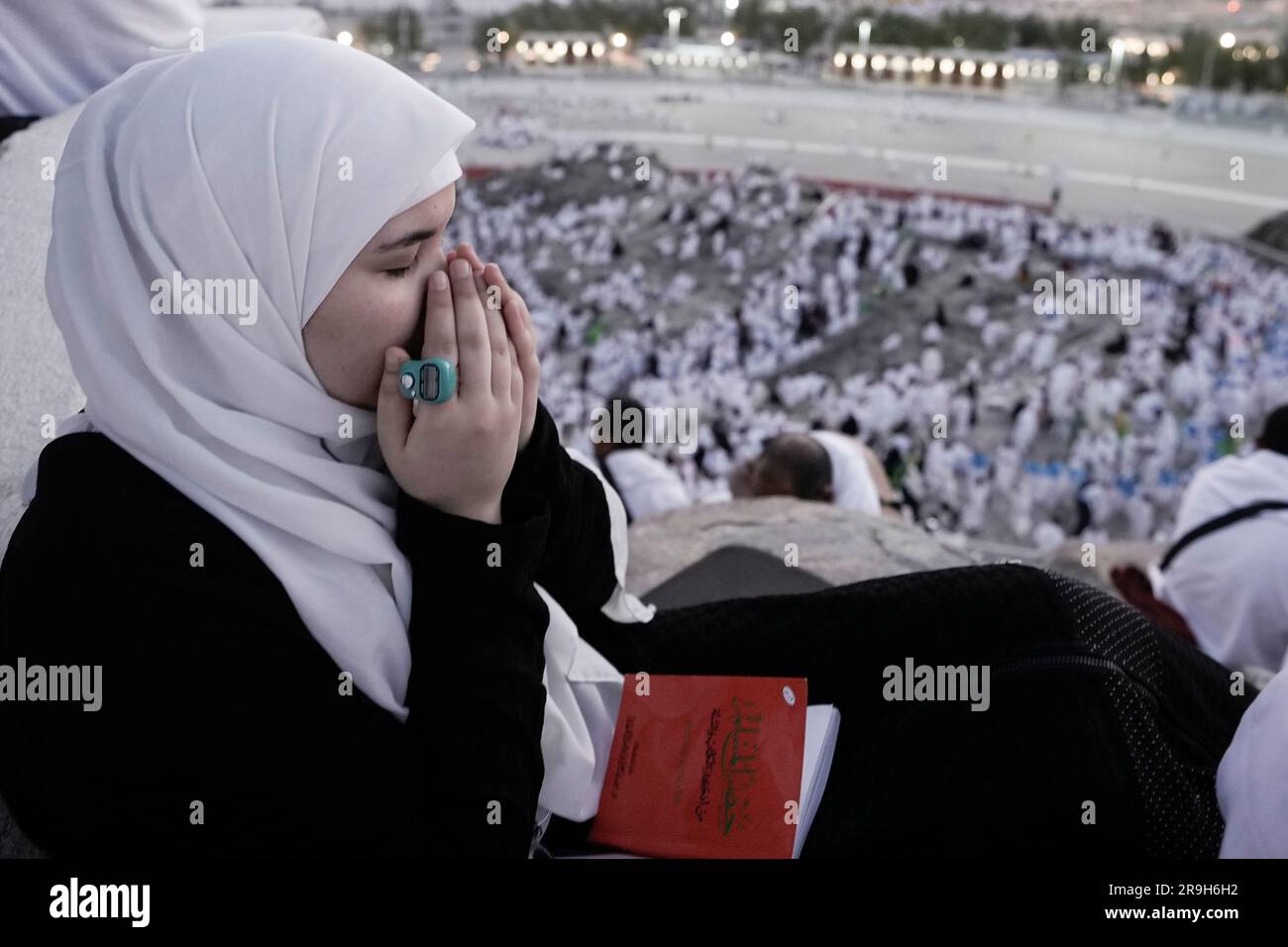 A Muslim pilgrim prays on the rocky hill known as the Mountain of Mercy ...