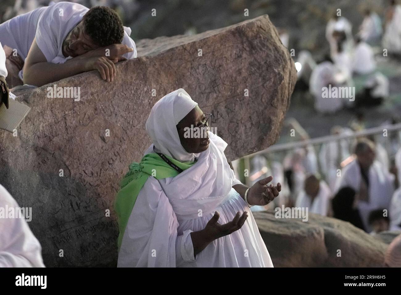 A Muslim pilgrim prays on the rocky hill known as the Mountain of Mercy ...