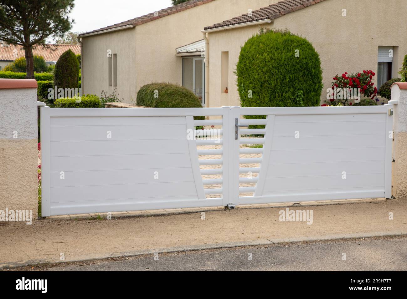 white gate pvc plastic portal with panel blades in city suburbs house ...