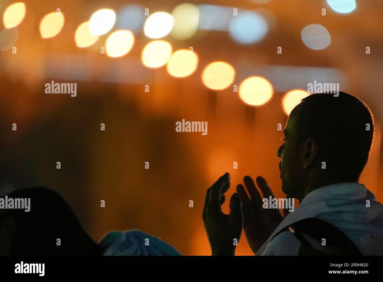 A Muslim pilgrim prays on the rocky hill known as the Mountain of Mercy ...