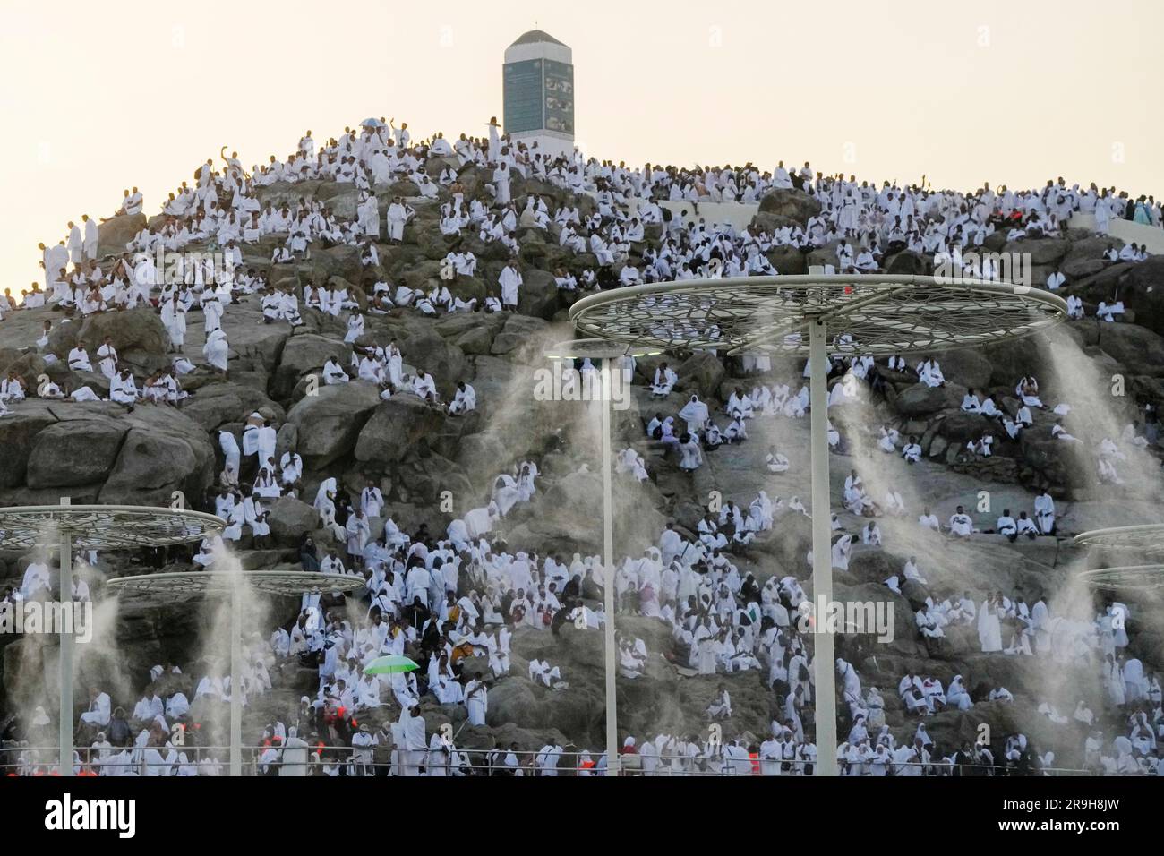 Water mist is sprayed on Muslim pilgrims as they pray on the rocky hill ...