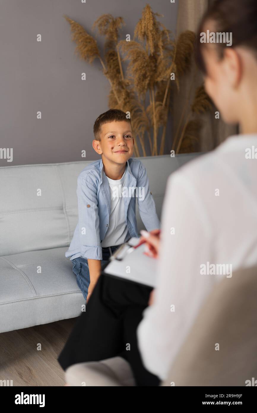 Preschooler boy visiting psychotherapist, woman and child talking about ...