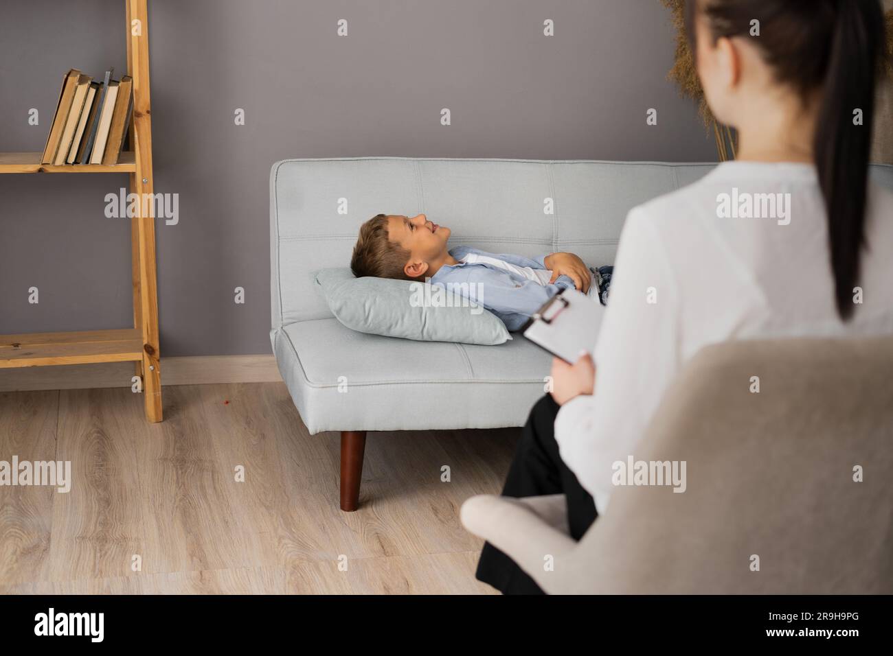 Psychologist working with teenage boy in her office. Psychologist ...