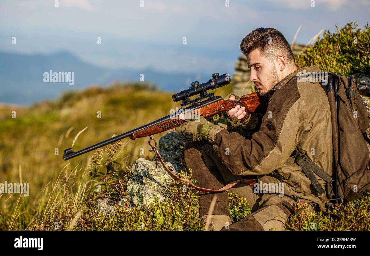 Hunter is aiming. Shooter sighting in the target. The man is on the ...