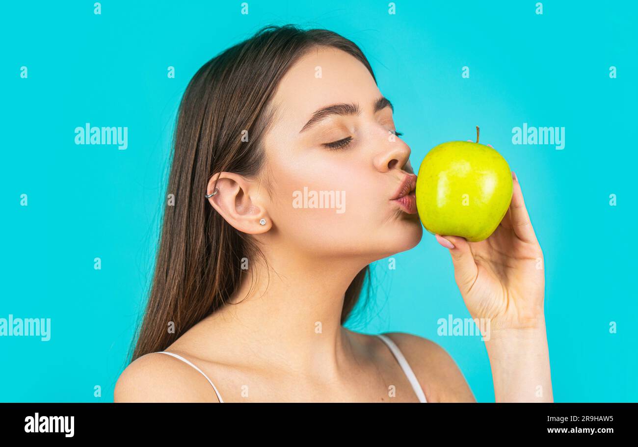Beautiful young woman eating an apple. Healthy lifestyle. Happy woman ...