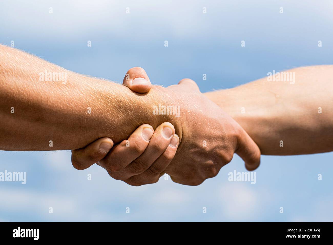 Friendly handshake, friends greeting, teamwork, friendship. Rescue, helping gesture or hands ...