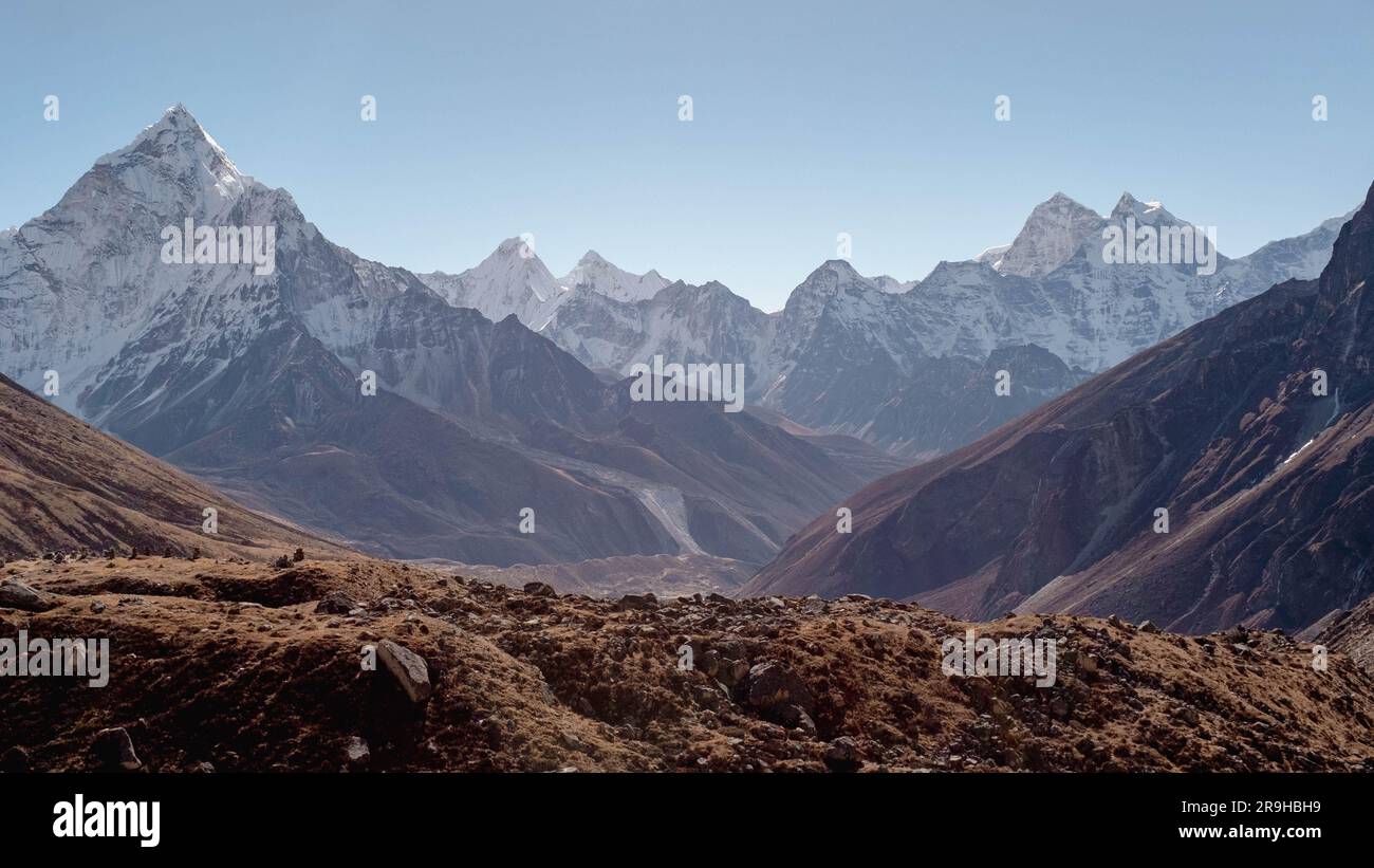 A majestic snowy mountain range with several prominent peaks in the ...