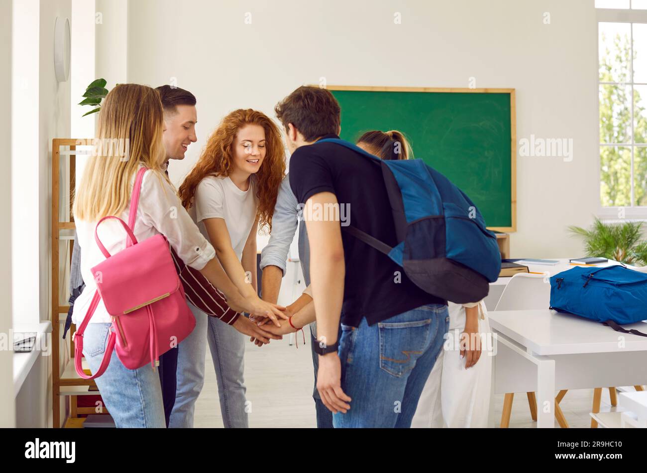 College students teamwork stacking hand hi-res stock photography and ...