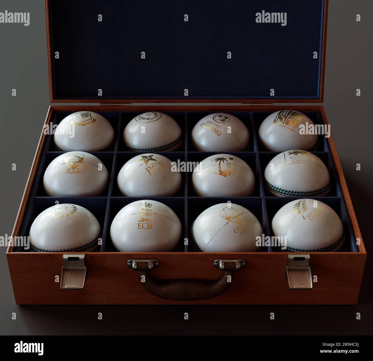 A collection of white cricket balls imprinted with gold logos of the ...
