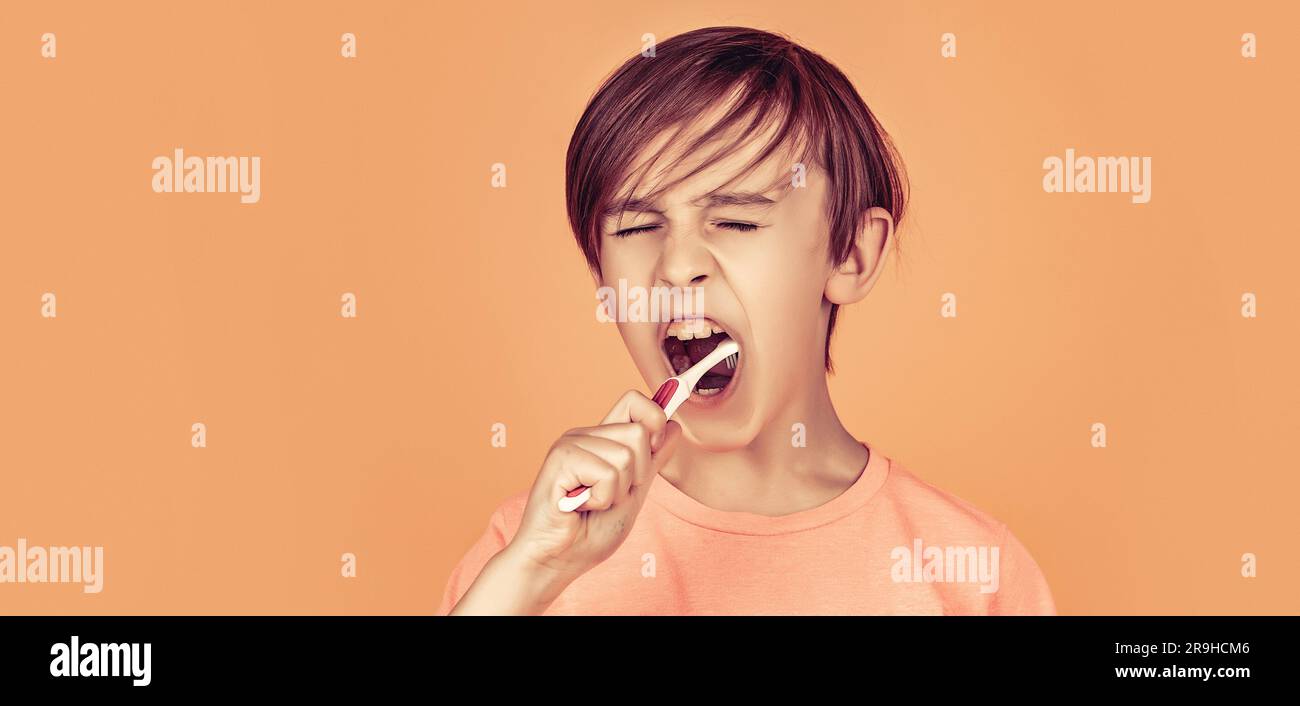 Little boy cleaning teeth with kids toothbrush. Happy child kid boy ...