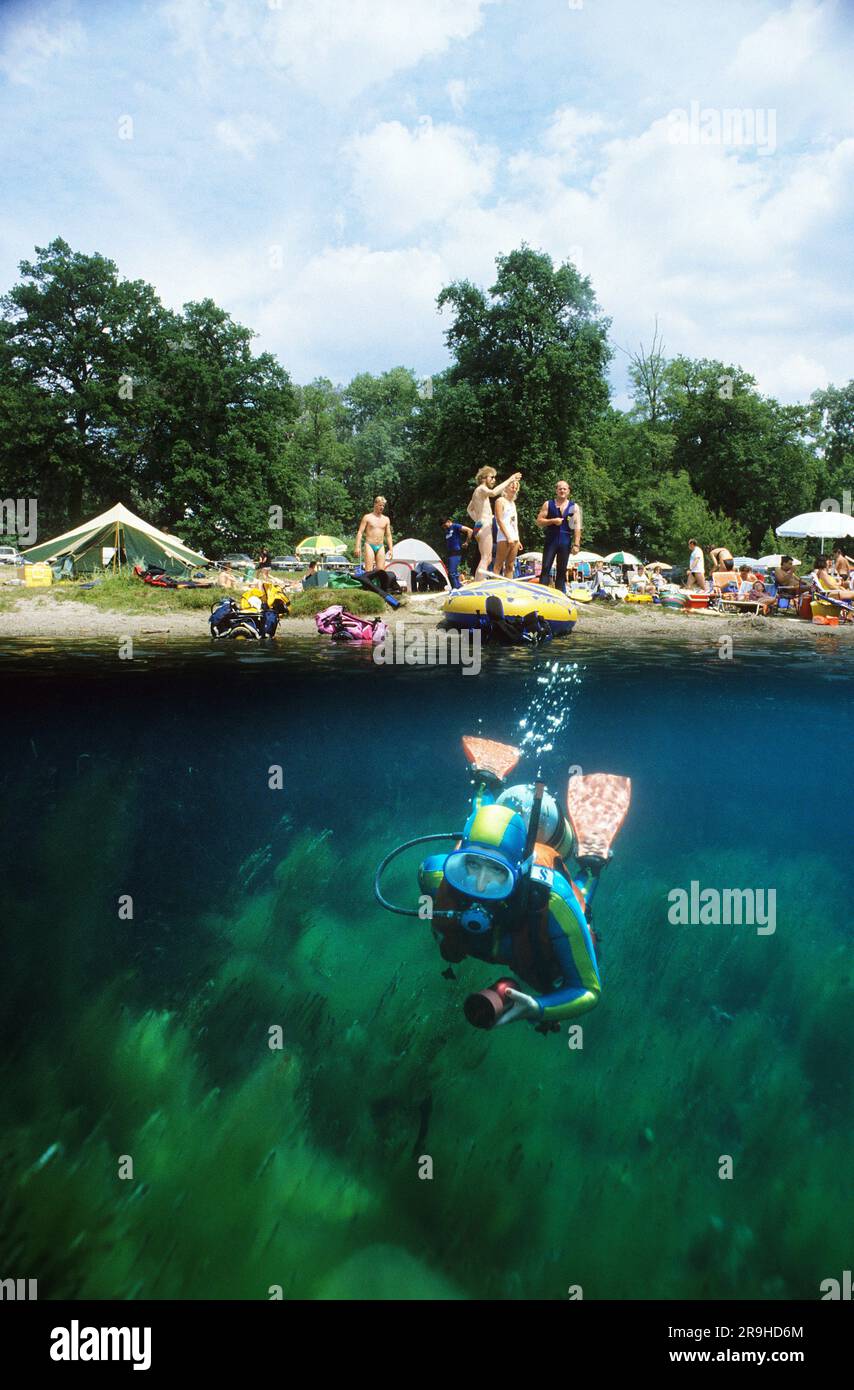 Split image, over under, beachlife at a lake, scuba diver under water ...
