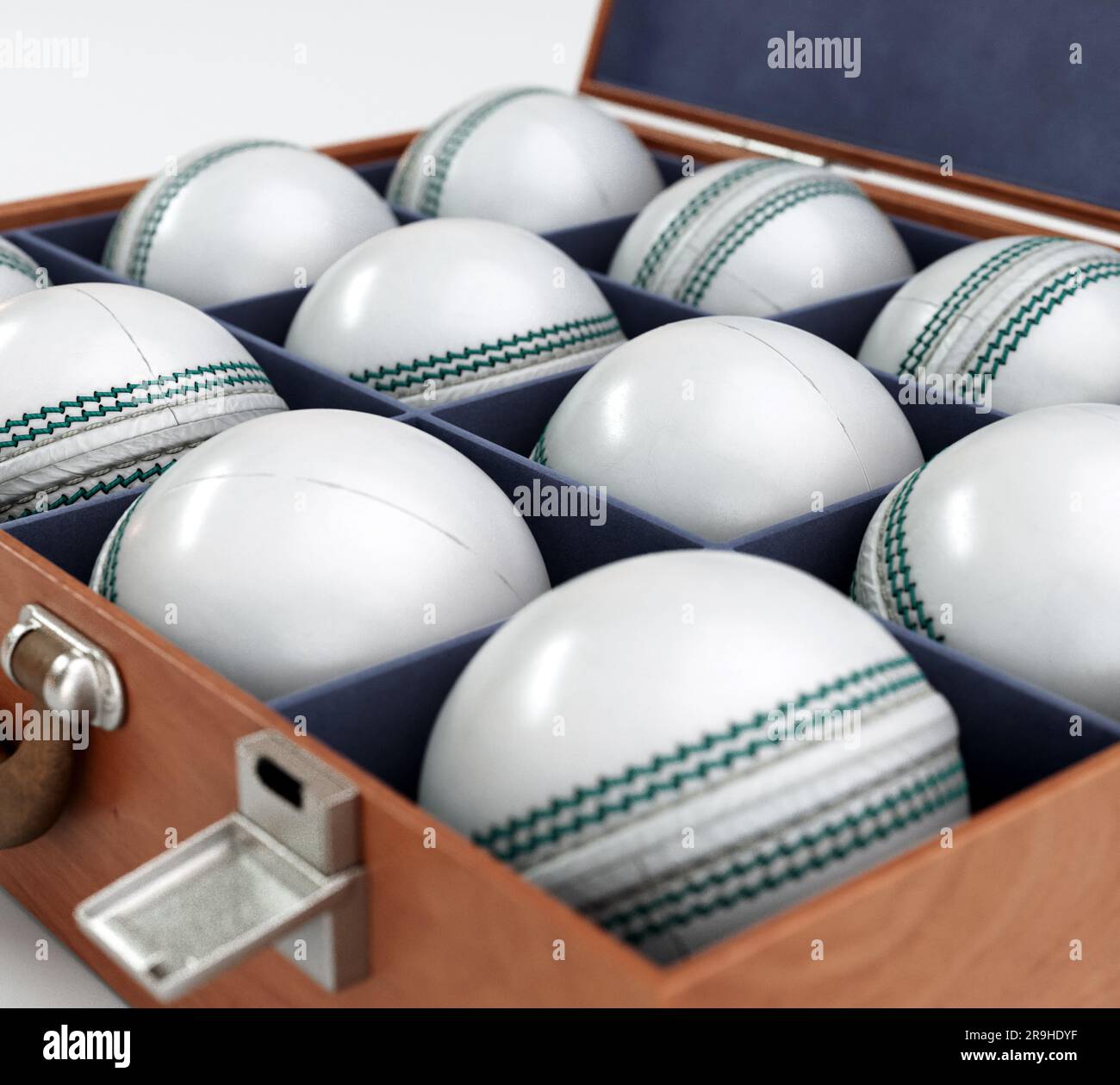 Twelve generic white cricket balls in a wooden display box lined with ...