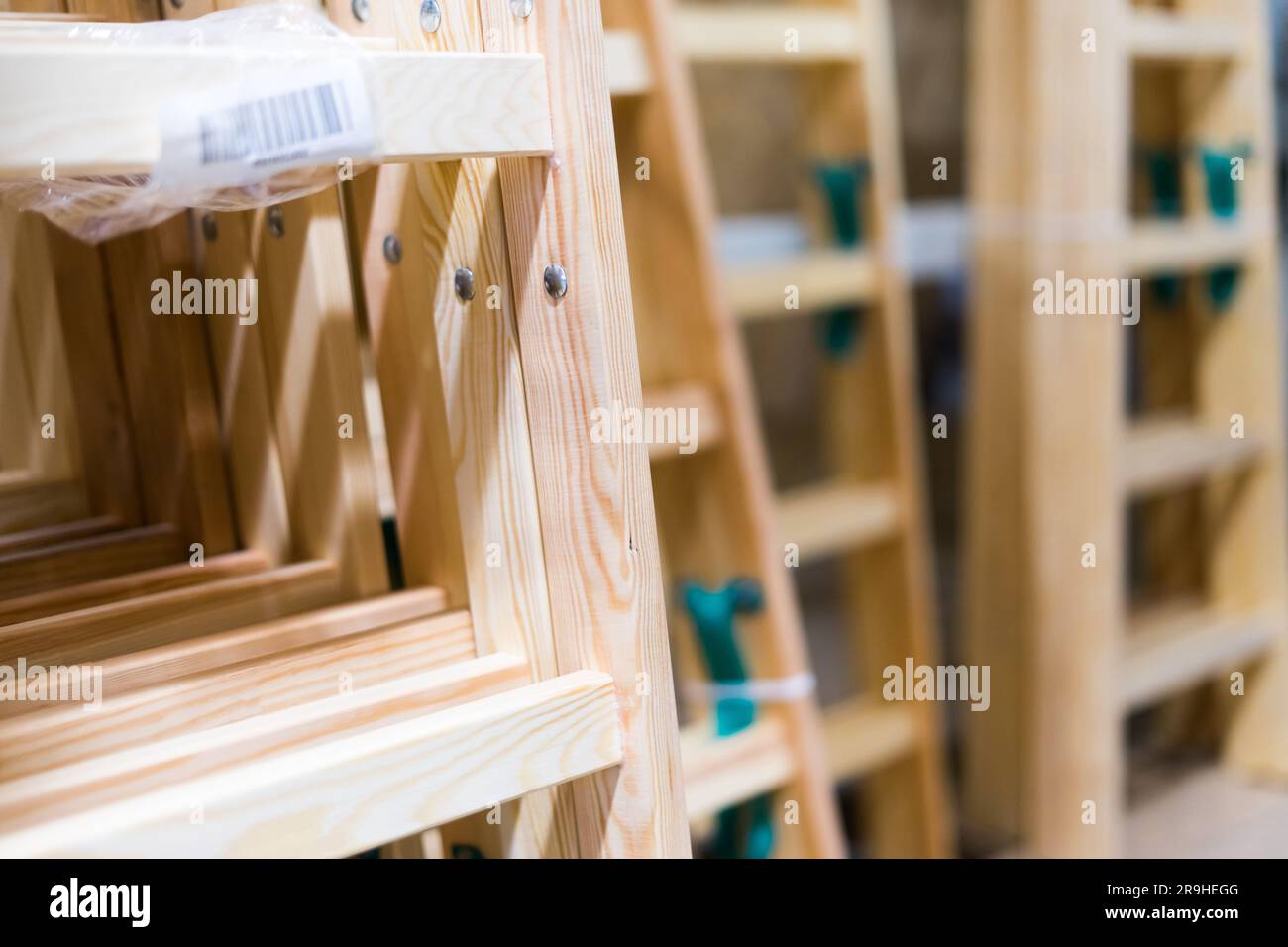 Many Wooden ladders. Stack of wooden stairs in a store Stock Photo - Alamy