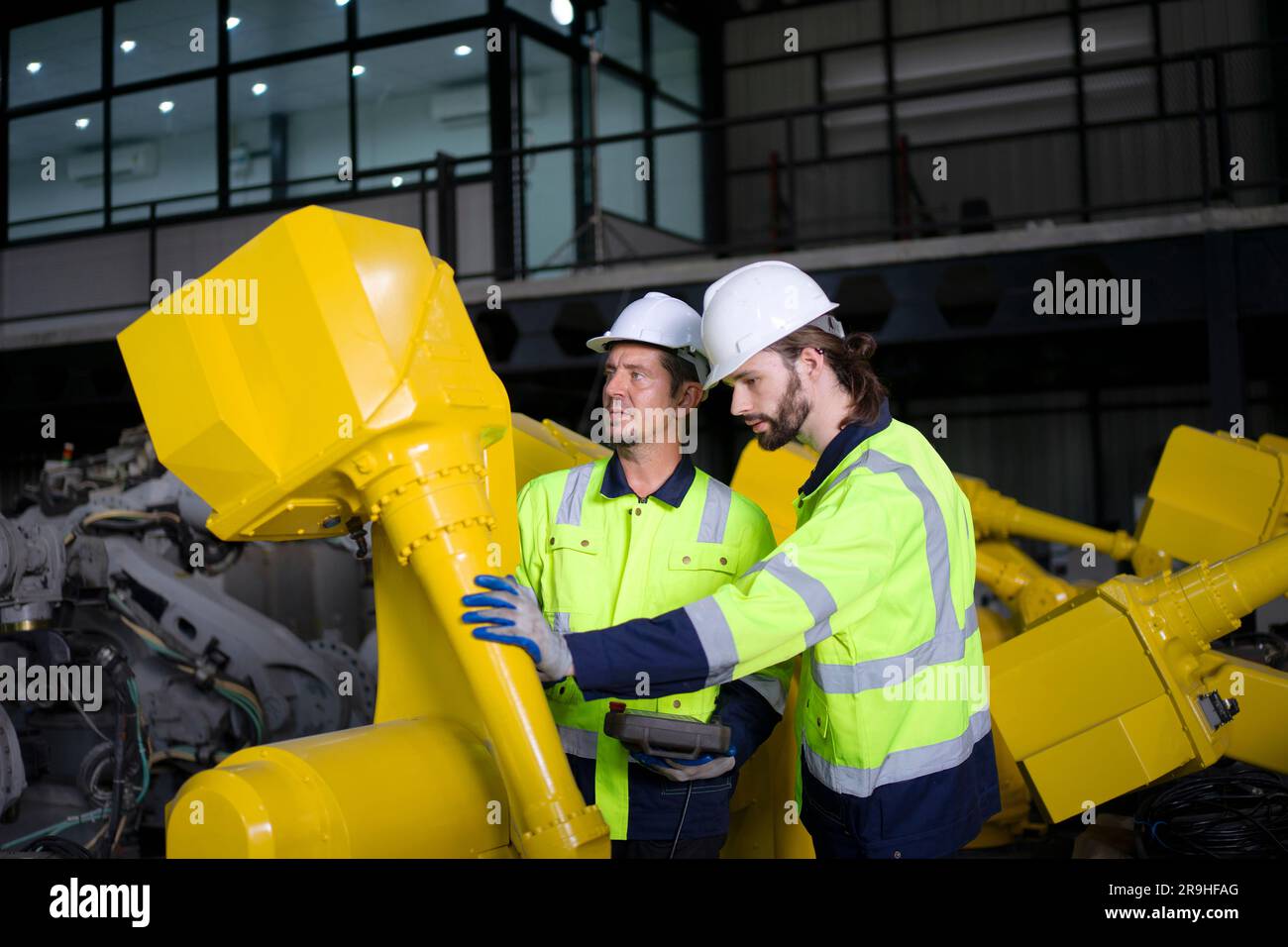 Engineer work at robotic arm factory. Technology and engineering concept Stock Photo - Alamy