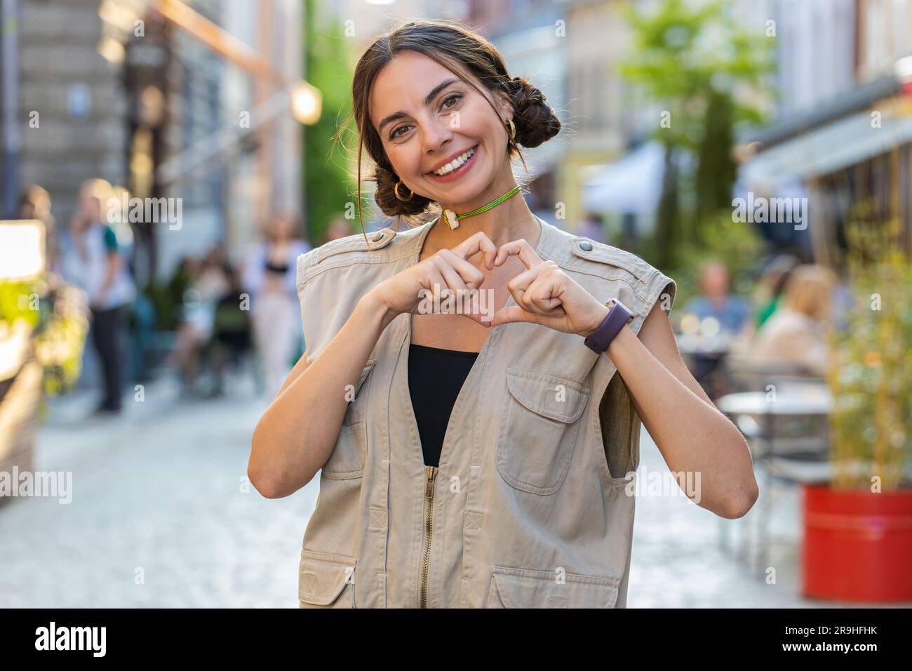 I love you. Young woman makes symbol of love, showing heart sign to ...