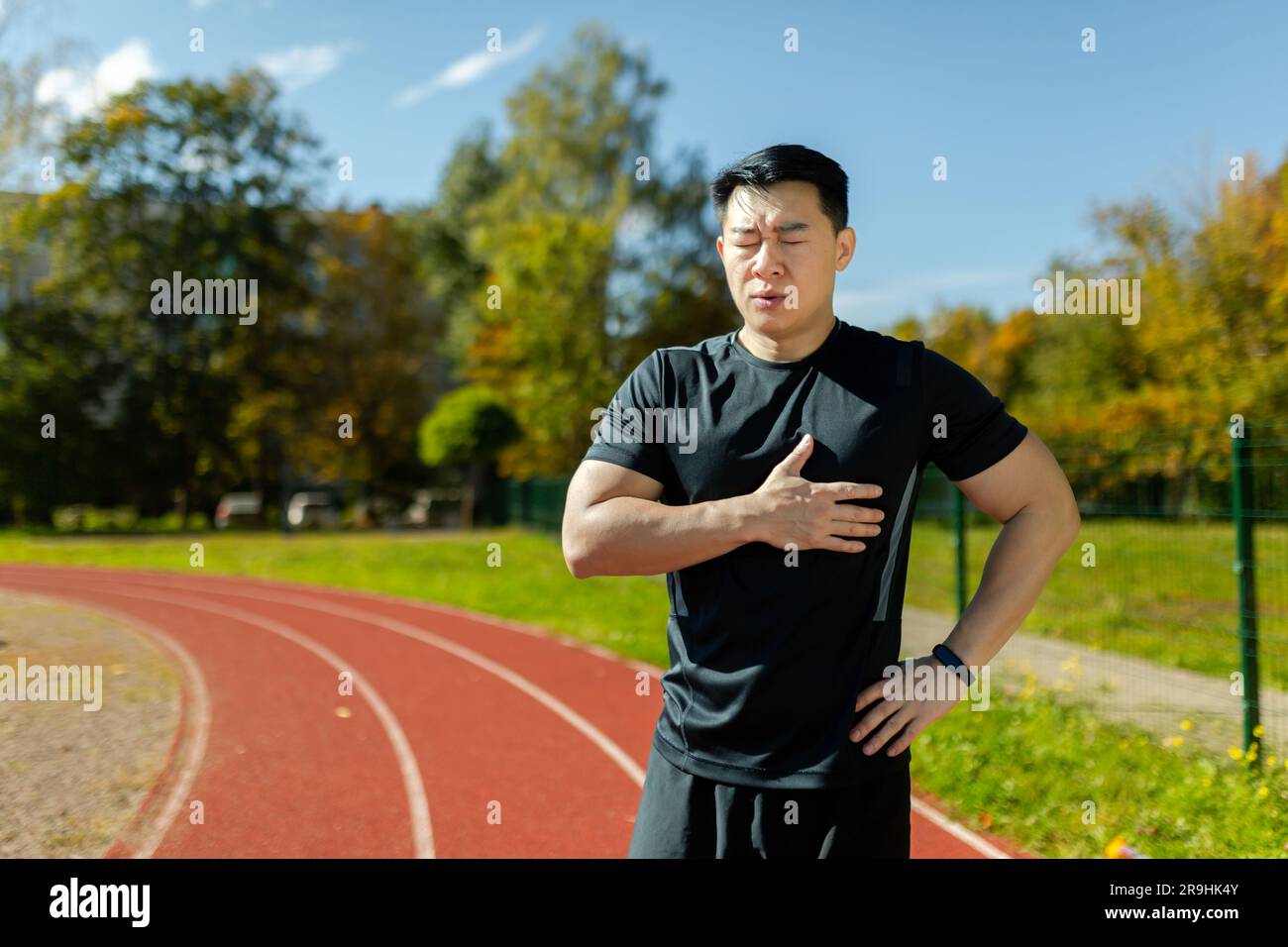 Asian tired and overworked while jogging and doing fitness active ...