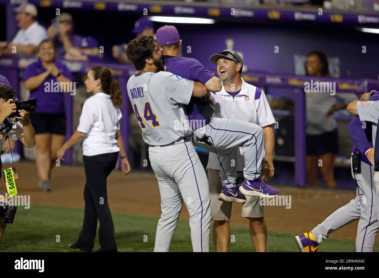LSU pitcher Blake Money (44) picks up head coach Jay Johnson after ...