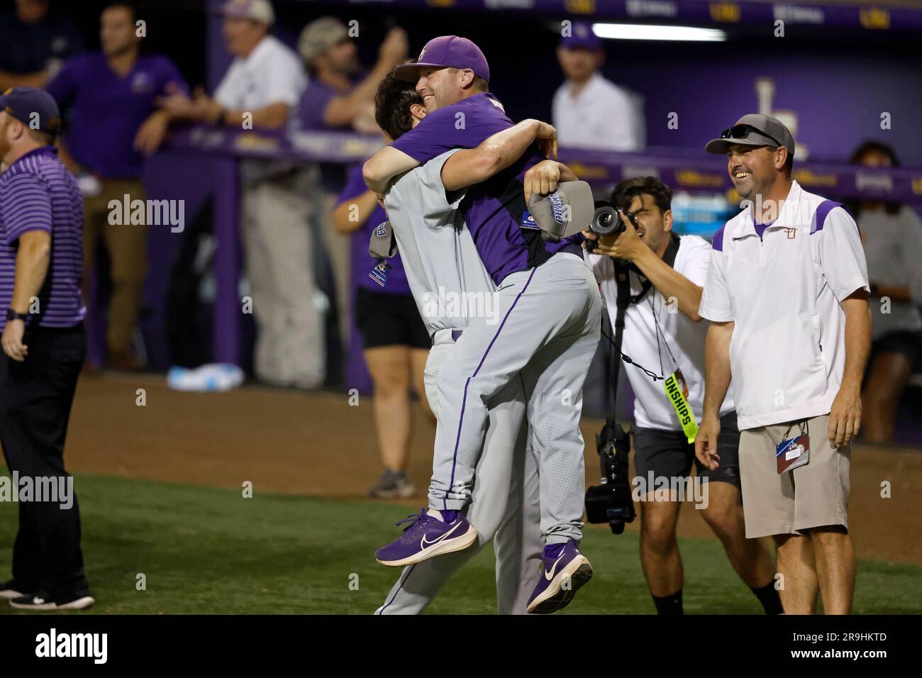 LSU pitcher Blake Money (44) picks up head coach Jay Johnson after ...