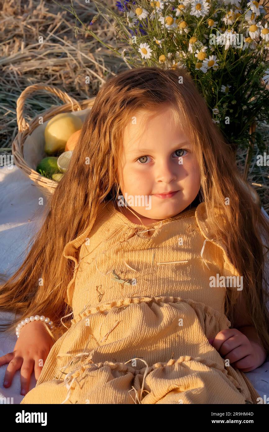 Portrait of a cute girl lying with her hair loose in the sun. Summer nymph. The long-awaited ...