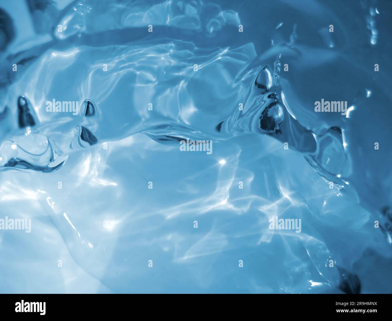 Blue ice and water close-up background Stock Photo - Alamy