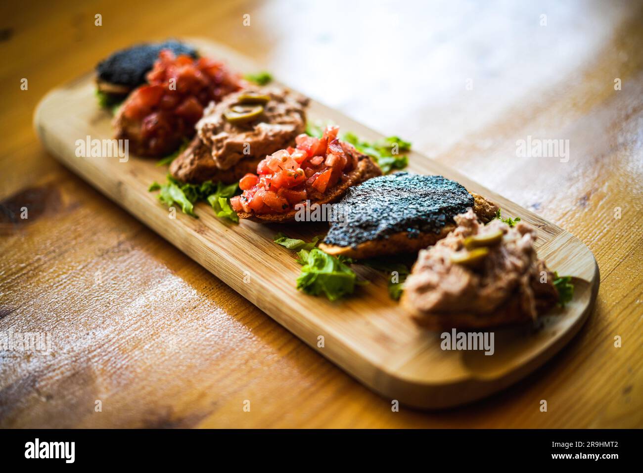 Selection of Spanish tapas served on a sliced baguette Stock Photo - Alamy