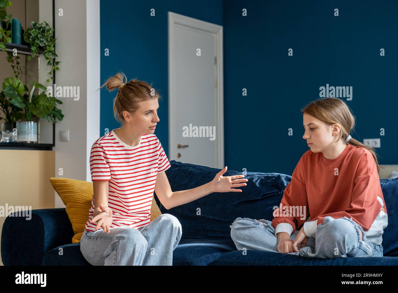 Excited mother spread arms while talk to teen daughter, ignoring misunderstanding of transition ...