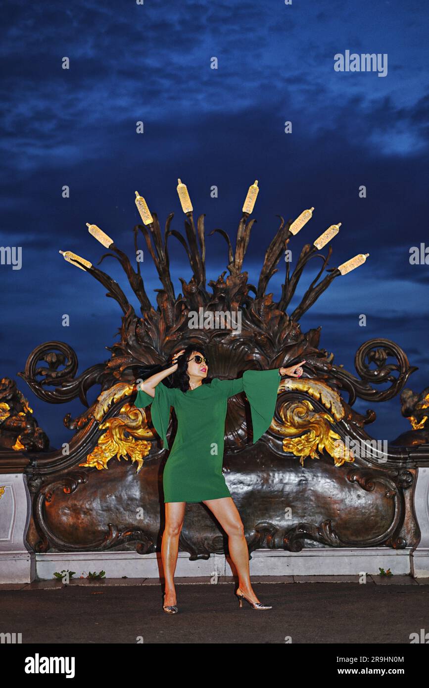 Paris by night, a glamorous, fashionable Middle Aged Asian Woman on ...