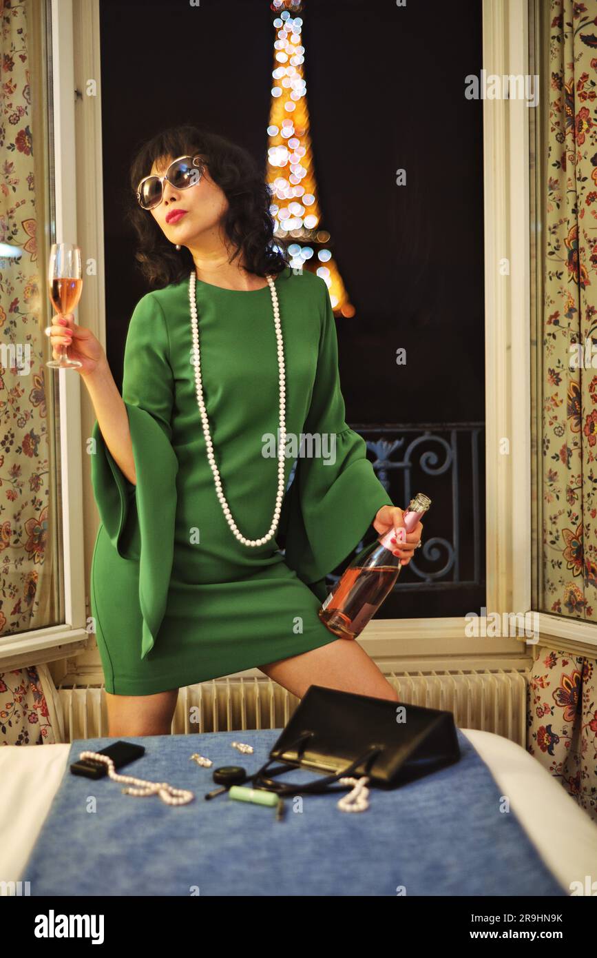 In Paris hotel room by an open French window with the Eiffel Tower ...