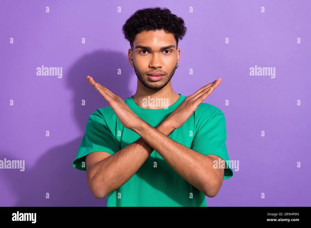 Photo of serious young guy protester activist cross his arms say no ...